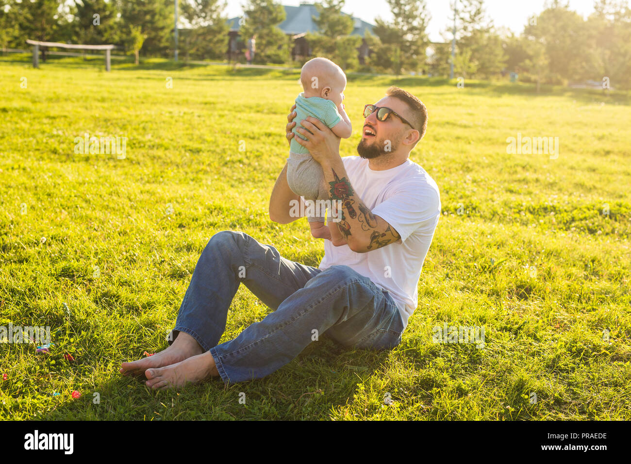 Happy father holding baby son on nature. Concept of happy family ...