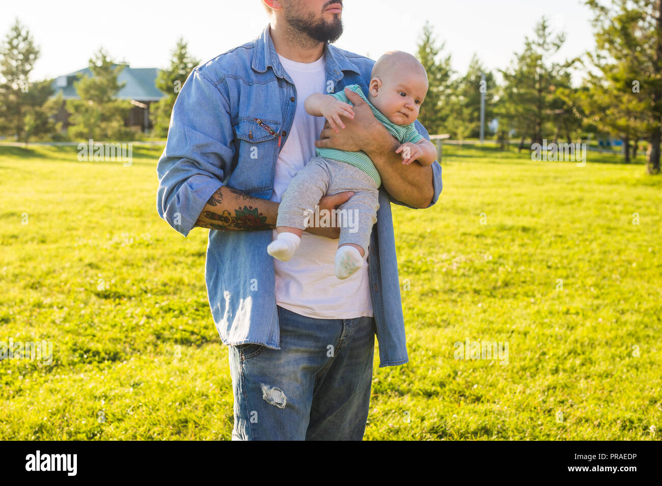Happy father holding baby son on nature. Concept of happy family ...