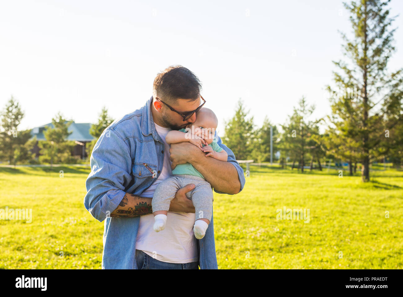 Happy father holding baby son on nature. Concept of happy family ...