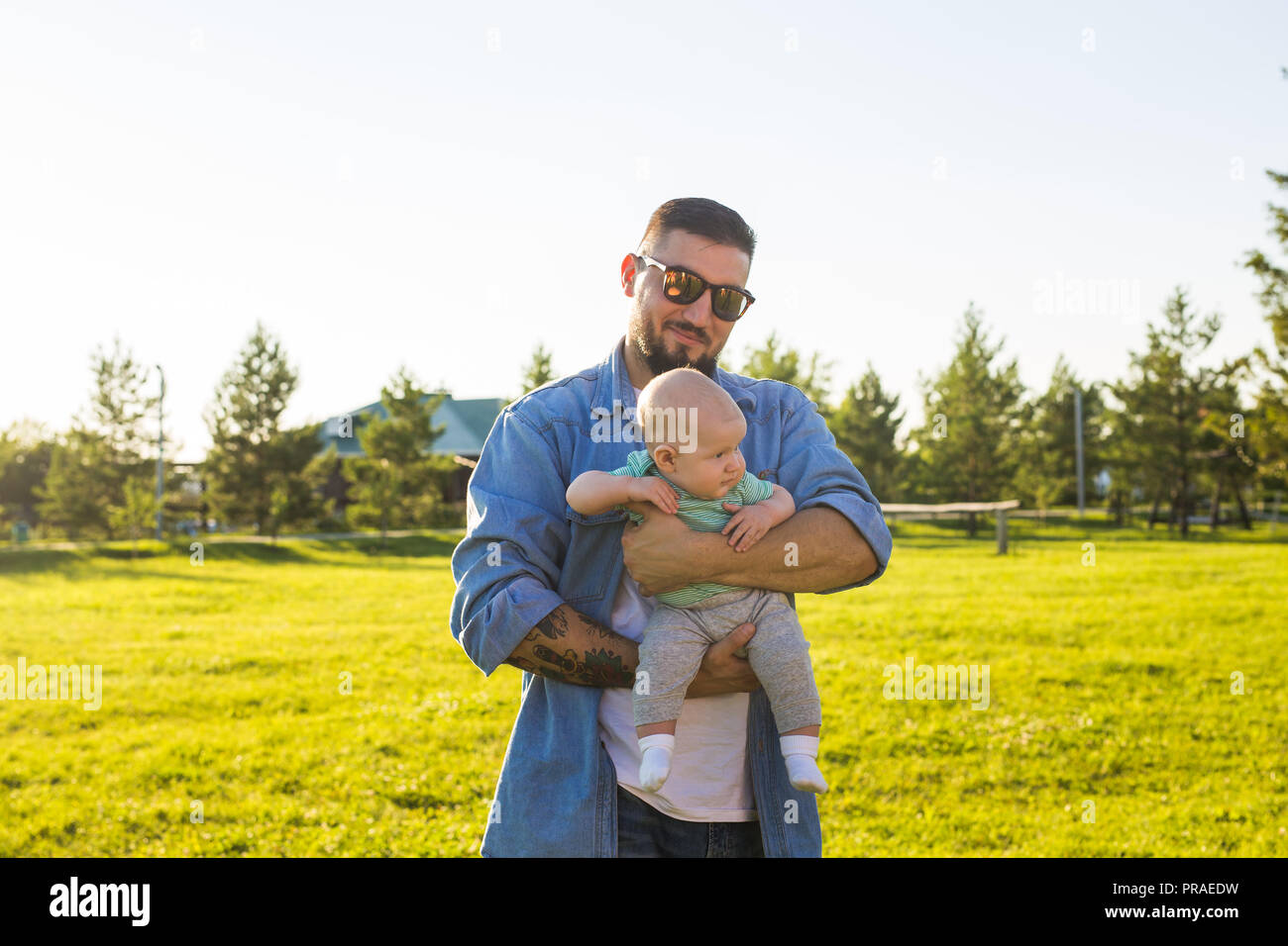 Happy father holding baby son on nature. Concept of happy family ...