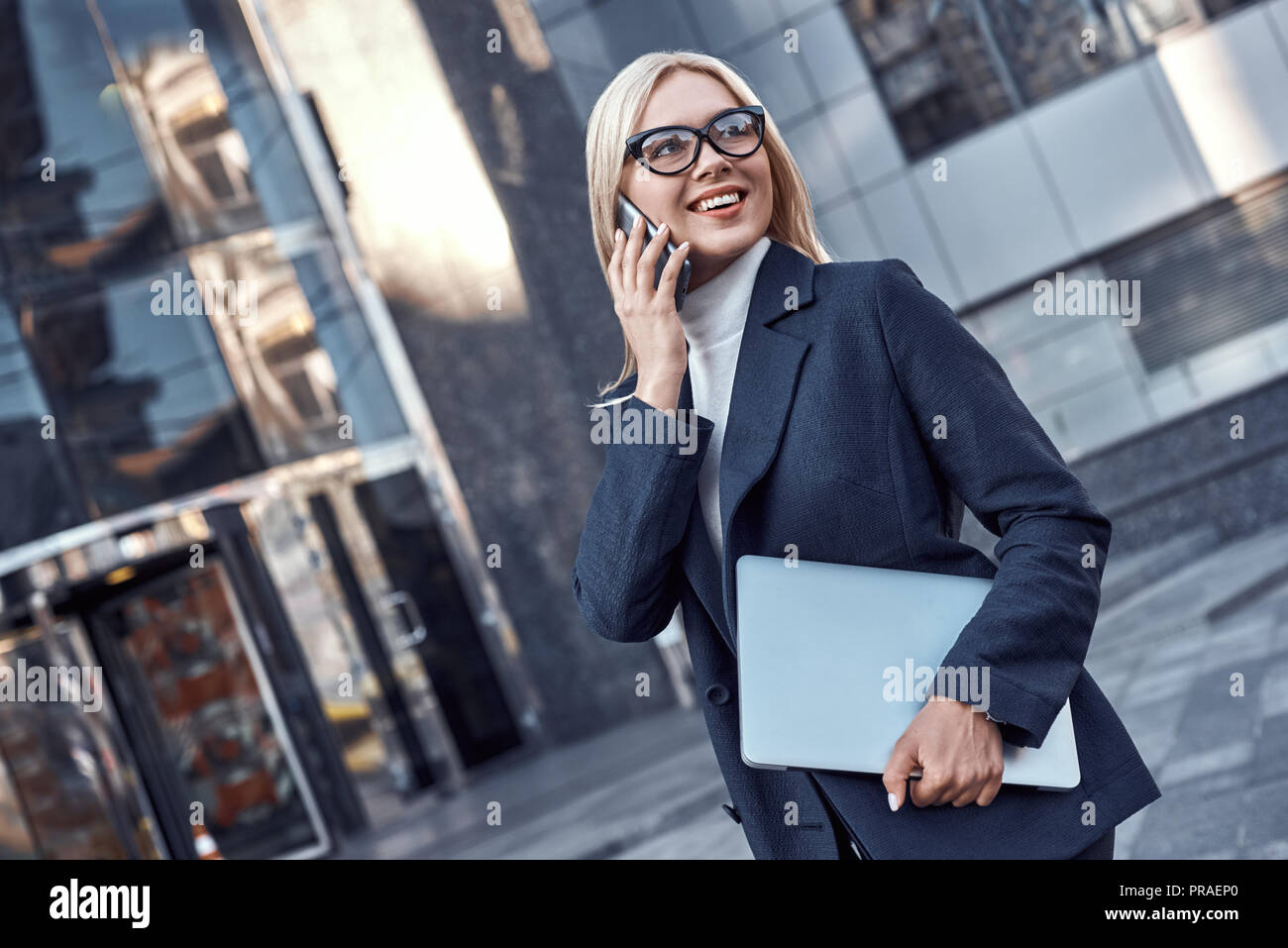Successful business woman working at laptop in City Stock Photo - Alamy