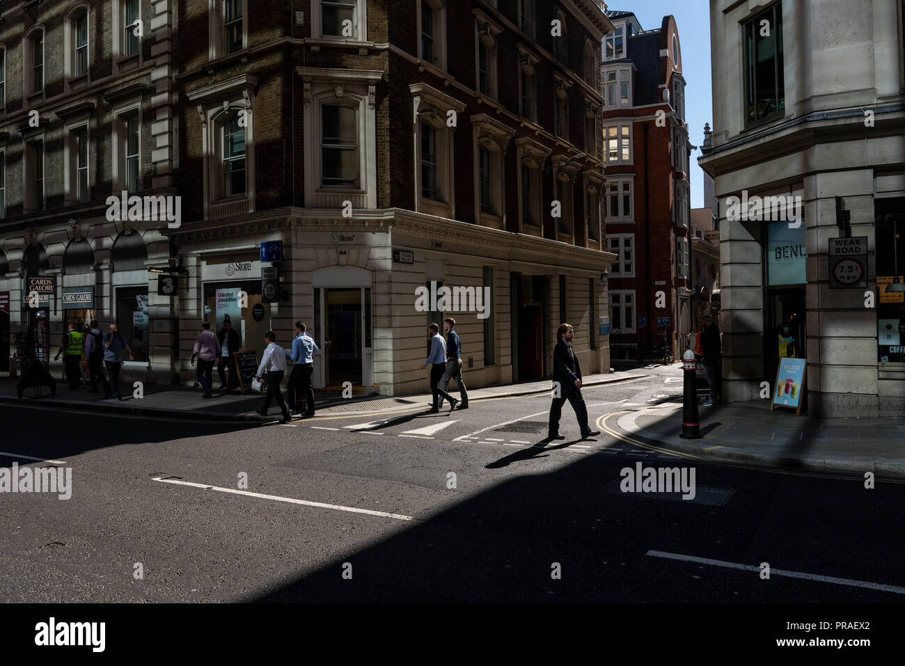 Office Workers scurrying about on their lunch break in the business ...