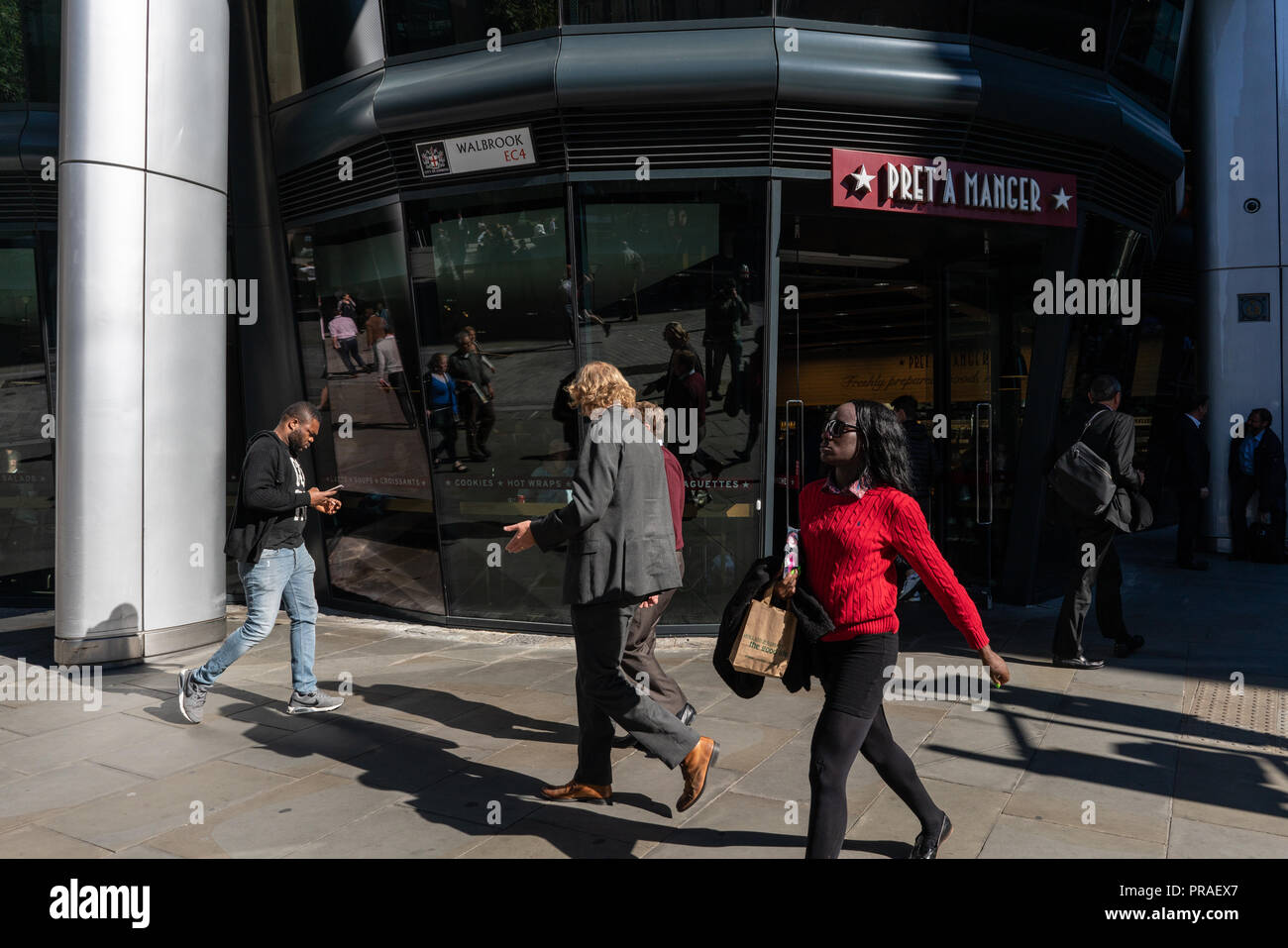 Office Workers scurrying about on their lunch break in the business ...