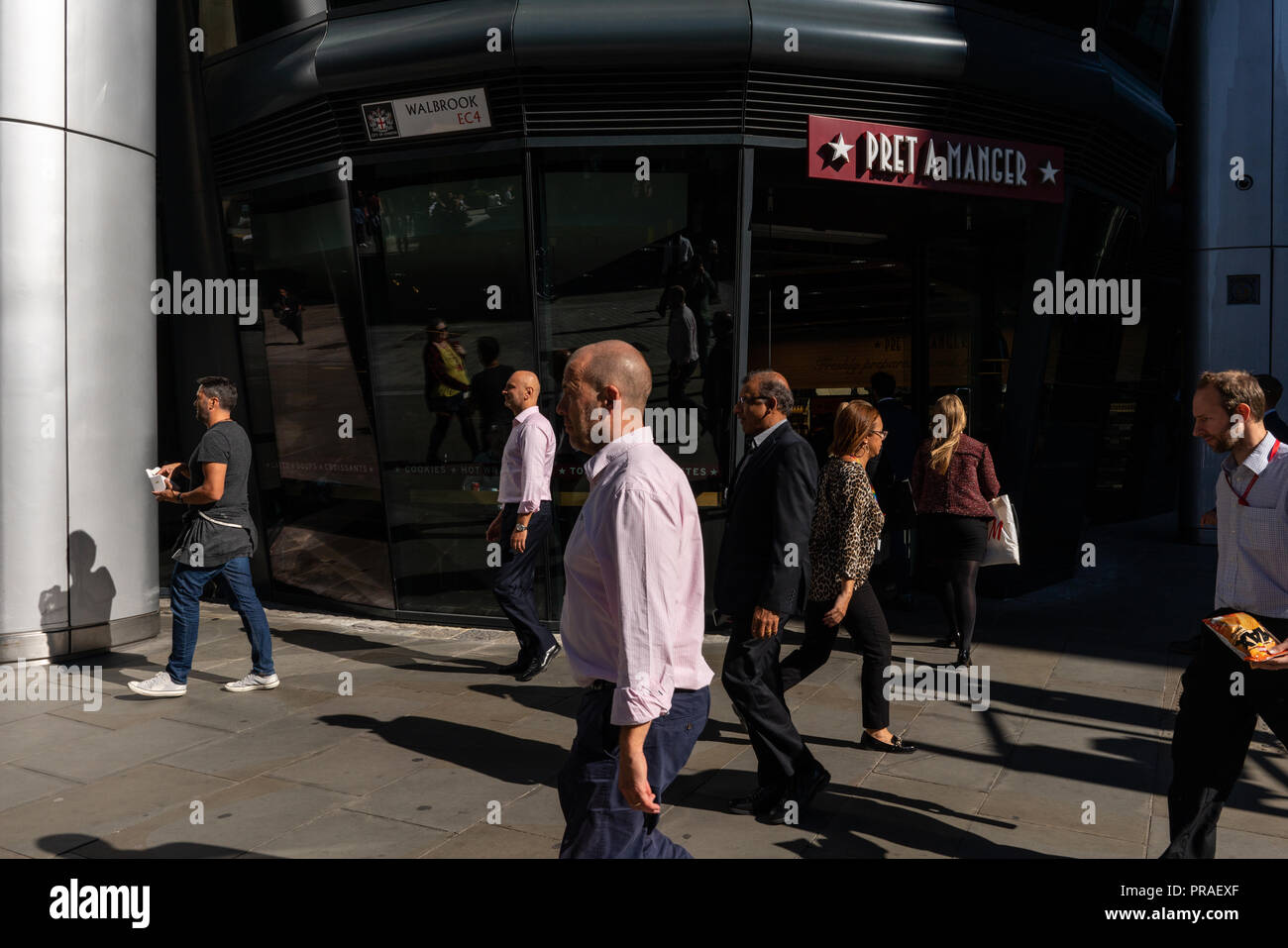 Office Workers scurrying about on their lunch break in the business ...