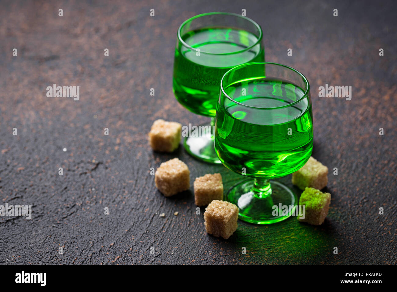 Glasses of absinthe with brown sugar Stock Photo - Alamy