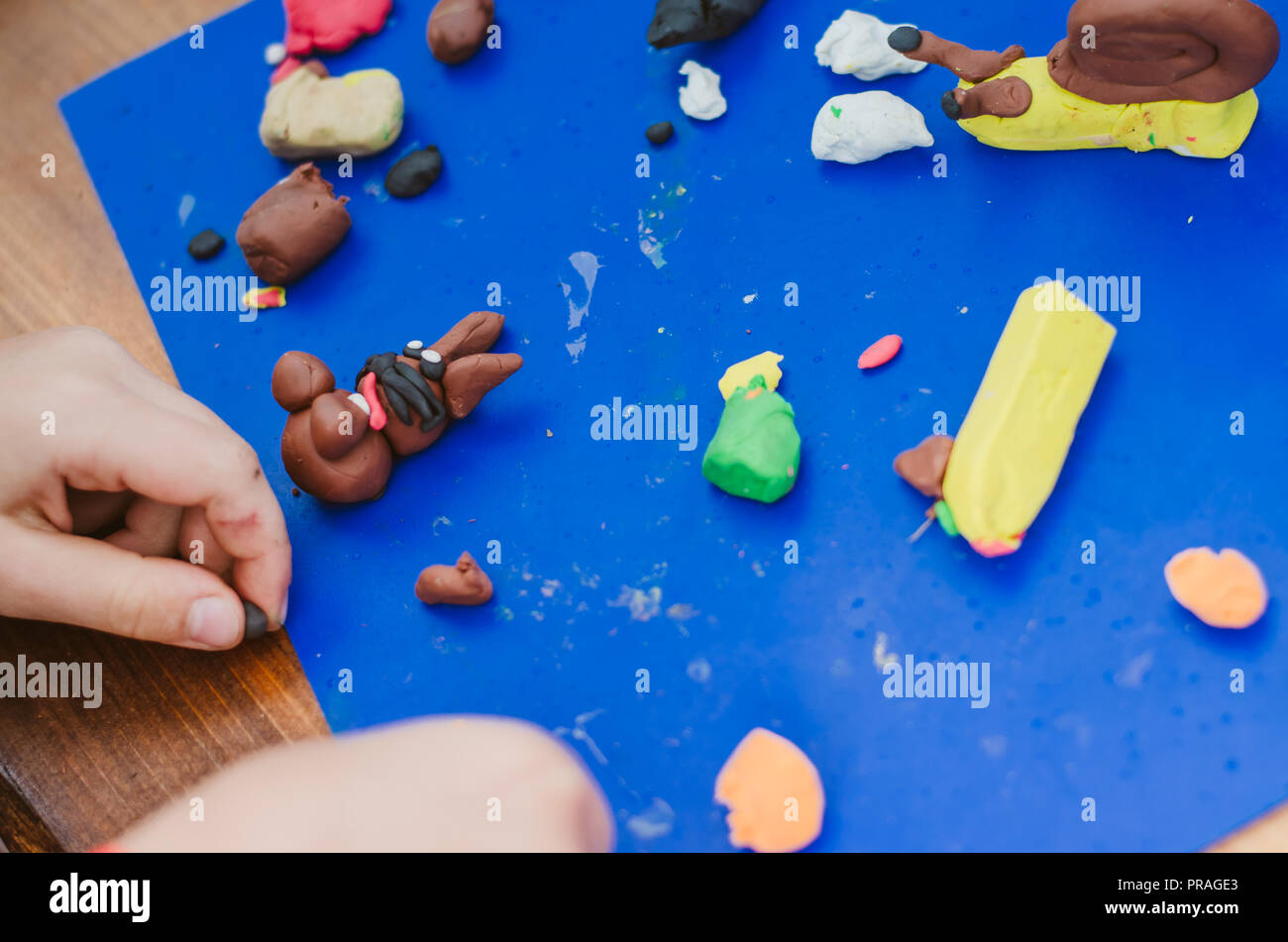 kids playing with play dough on the table Stock Photo - Alamy
