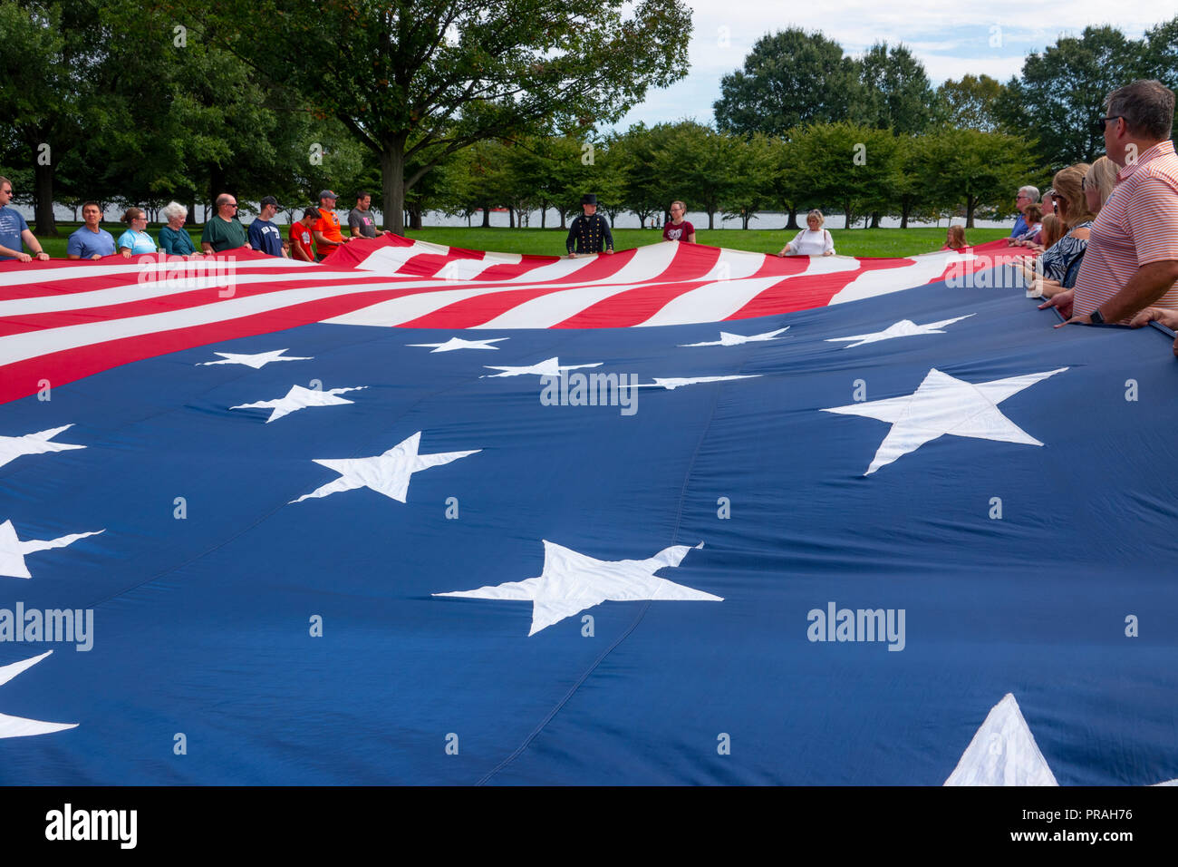 USA Maryland MD Baltimore Fort McHenry visitors hold up a large replica ...