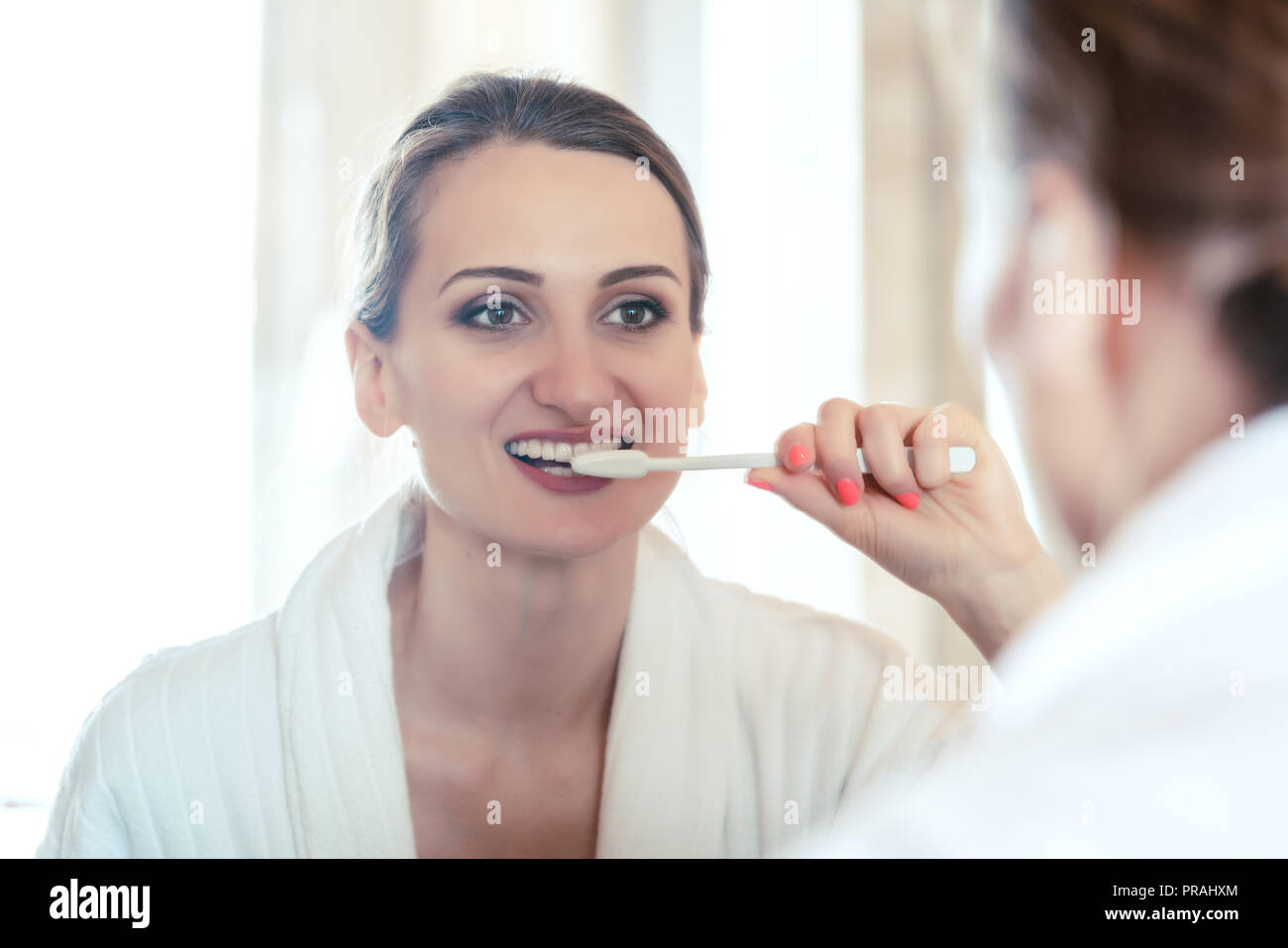 Woman brushing her teeth in hotel with hand brush Stock Photo - Alamy