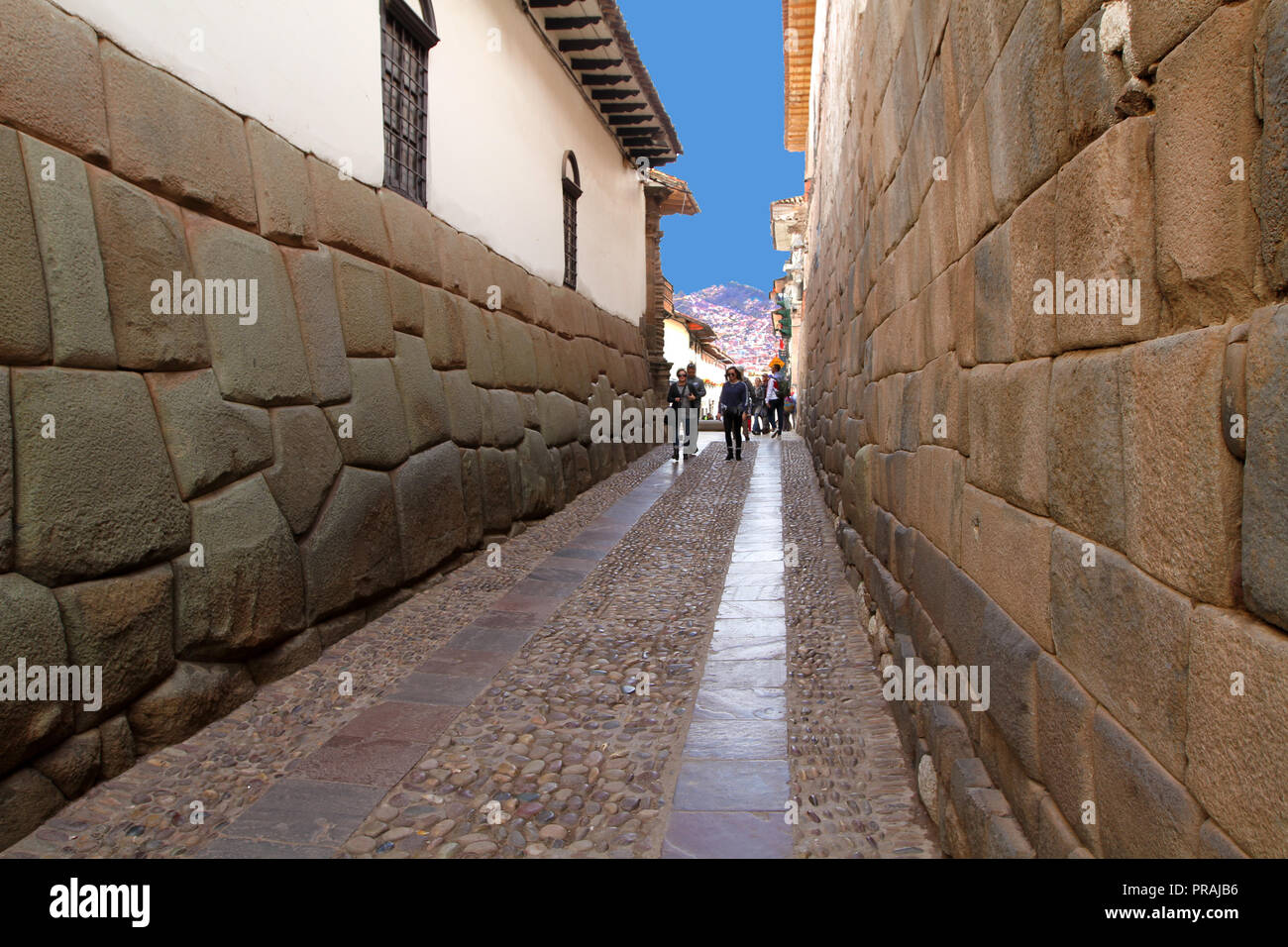 Inca stone foundations with colonial structures over them line alley ...