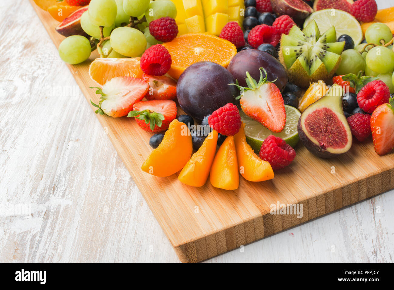 Healthy raw fruits and berries platter, strawberries raspberries ...
