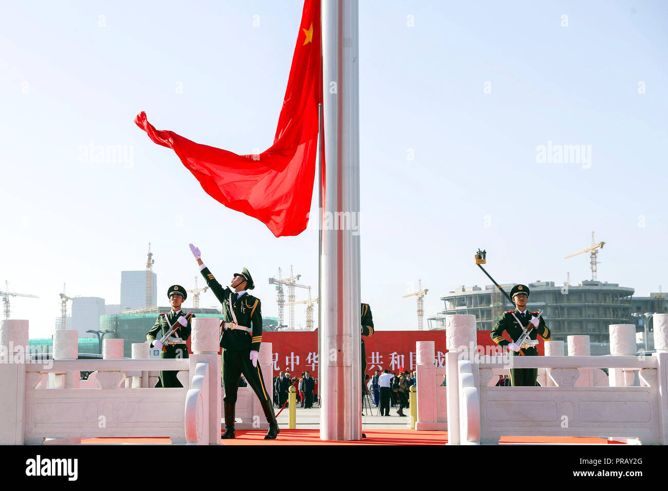 Urumqi. 1st Oct, 2018. A national flag raising ceremony is held at the ...