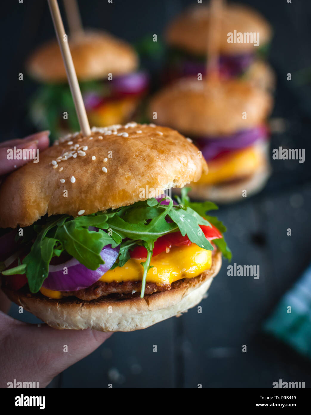 Close-up of hand holding homemade fresh burger Stock Photo - Alamy