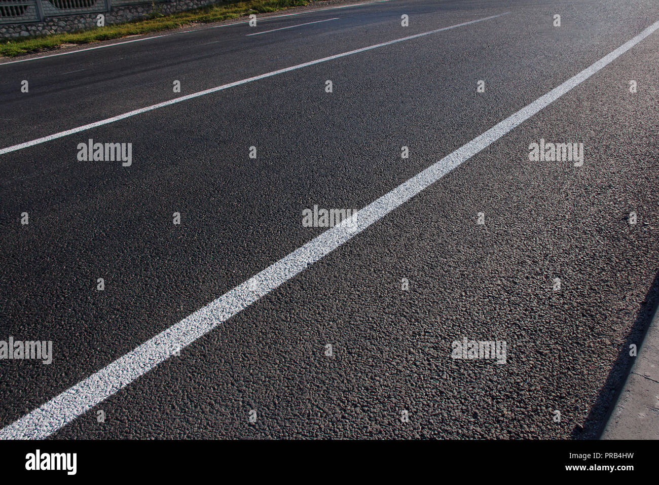 Asphalt road with marking lines white stripes Stock Photo - Alamy