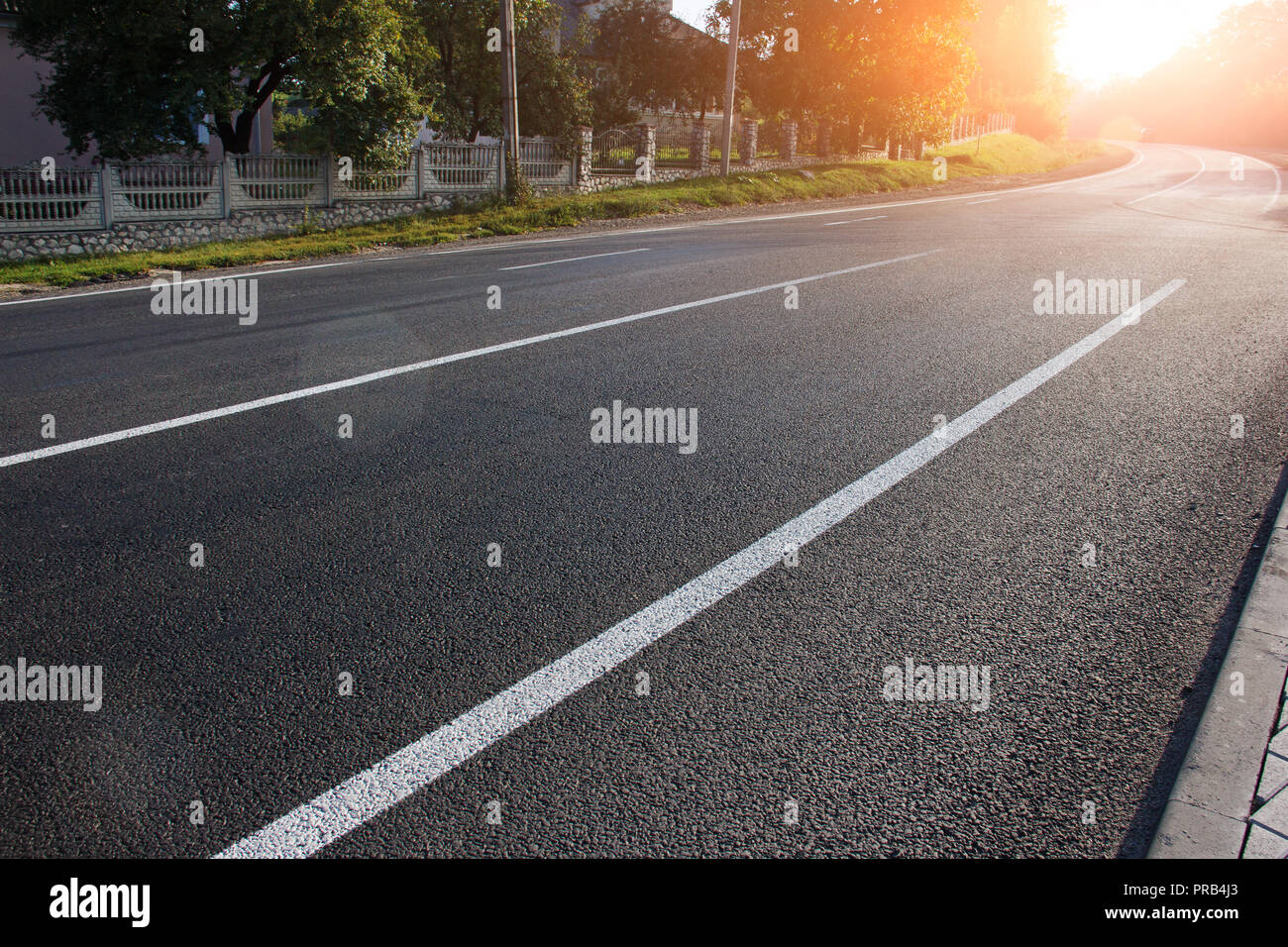 Asphalt road with marking lines white stripes Stock Photo - Alamy