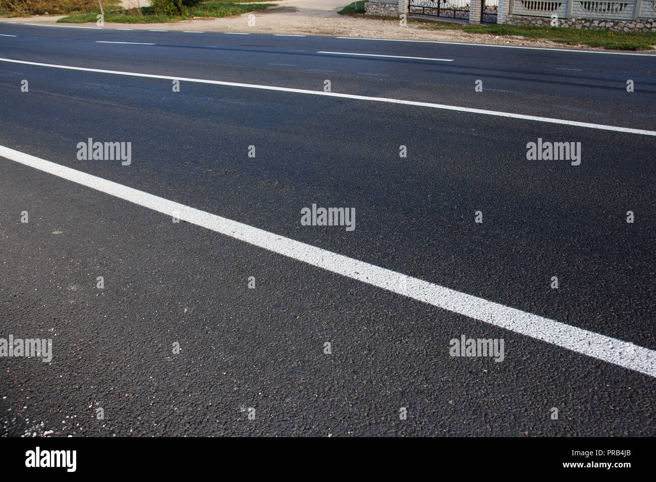 Asphalt road with marking lines white stripes Stock Photo - Alamy