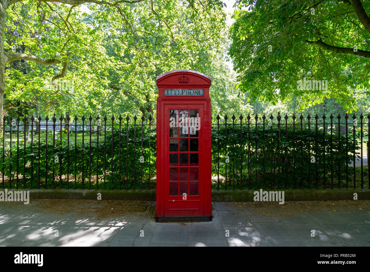 Typical red English telephone booth in the park. London, UK Stock Photo ...
