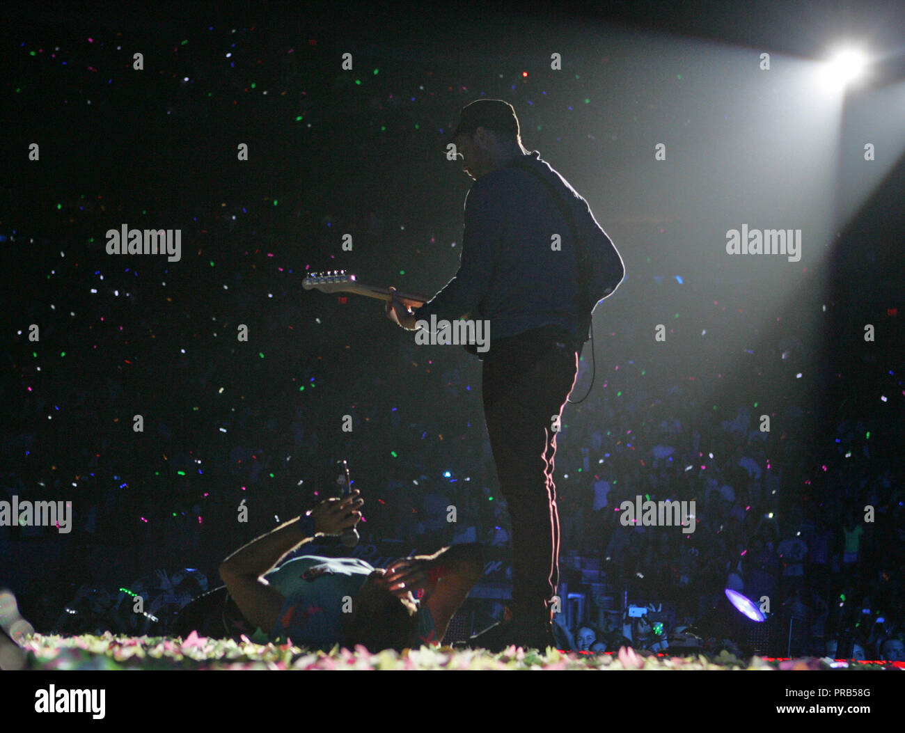 Chris Martin and Jonny Buckland (R) with Coldplay perform in concert on ...