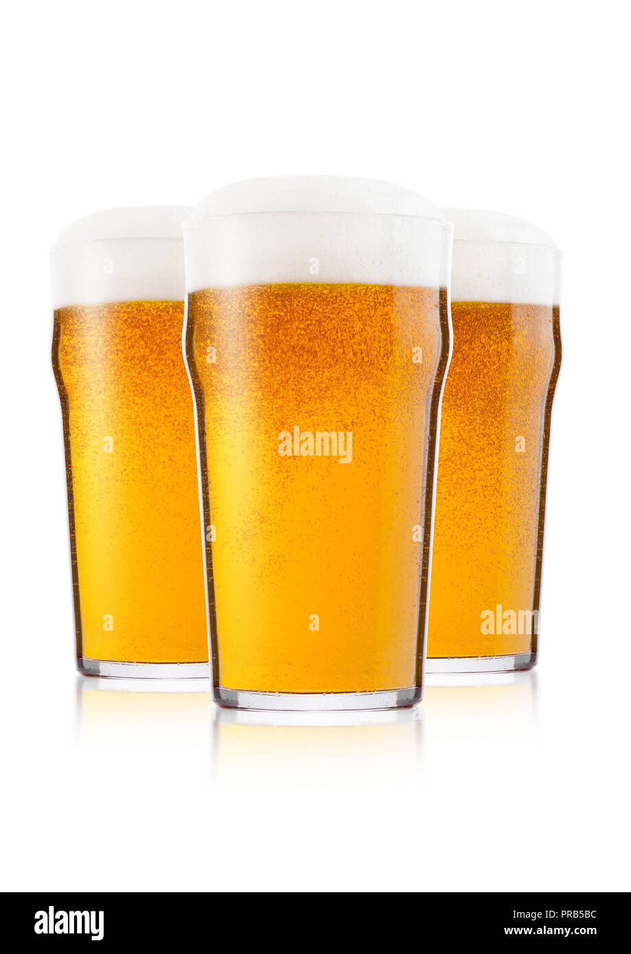 Cold glasses of lager beer with foam and dew on white background with ...