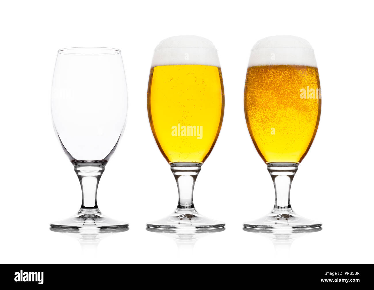 Cold glasses of lager beer with foam and dew on white background with ...