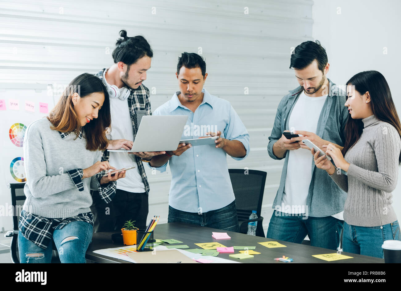 Diversity Designer in casual cloth using technology device at meeting ...
