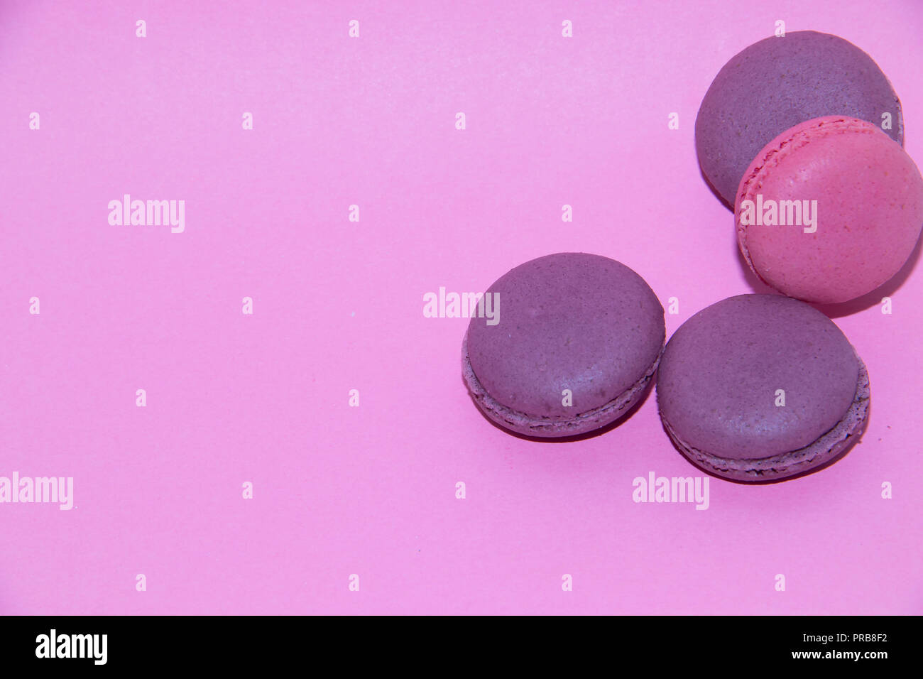 Macaroni on a gently pink background. Delicious cakes for tea. Dessert ...