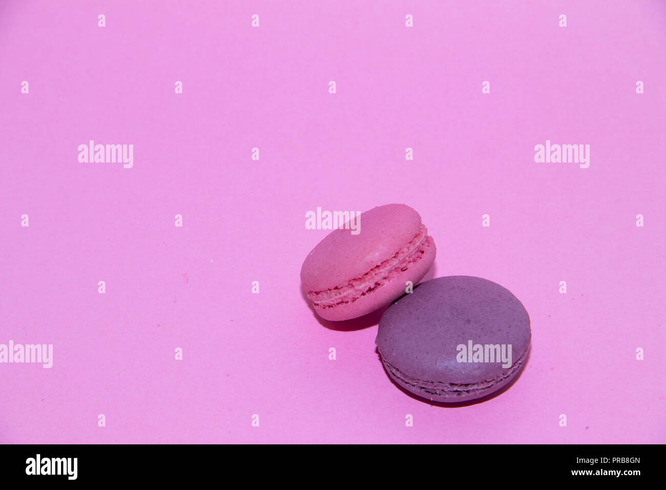 Macaroni on a gently pink background. Delicious cakes for tea. Dessert ...