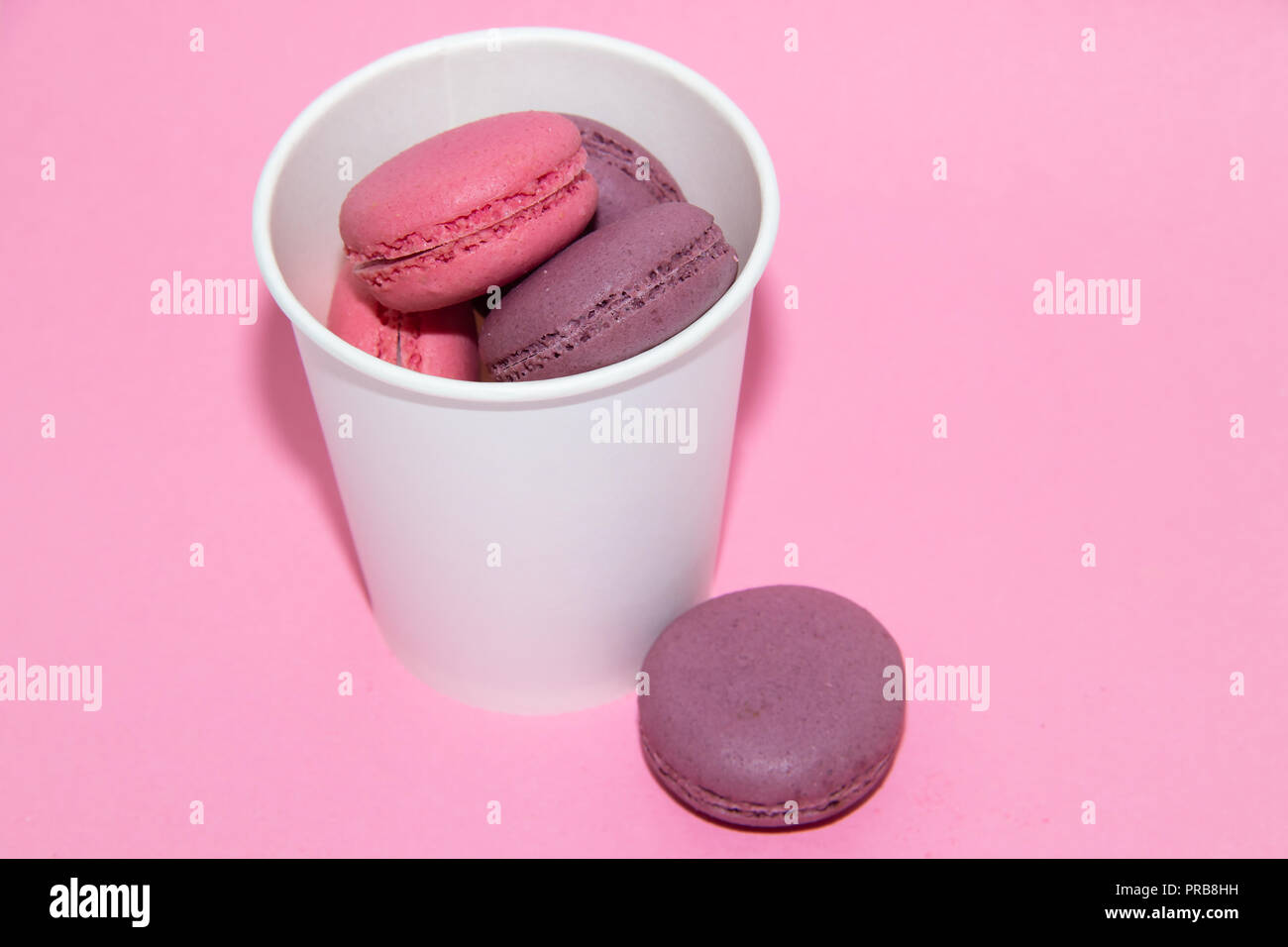 Macaroni on a gently pink background. Delicious cakes for tea. Dessert ...