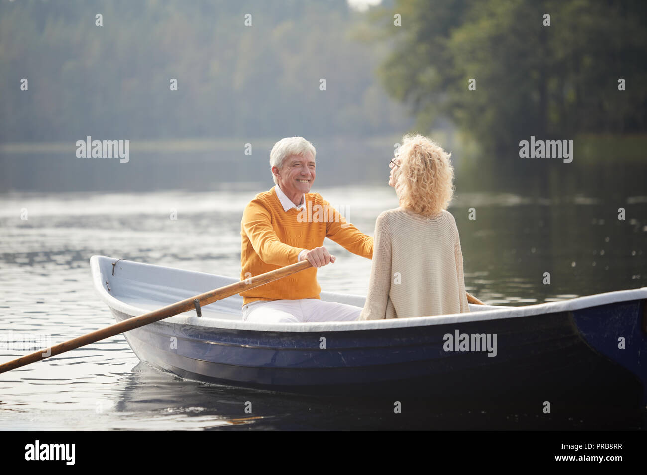 Cheerful excited affectionate senior man in yellow sweater falling in ...