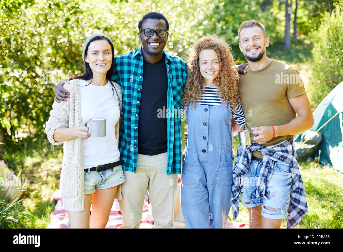 Group of cheerful affectionate friends enjoying backpack trip in ...