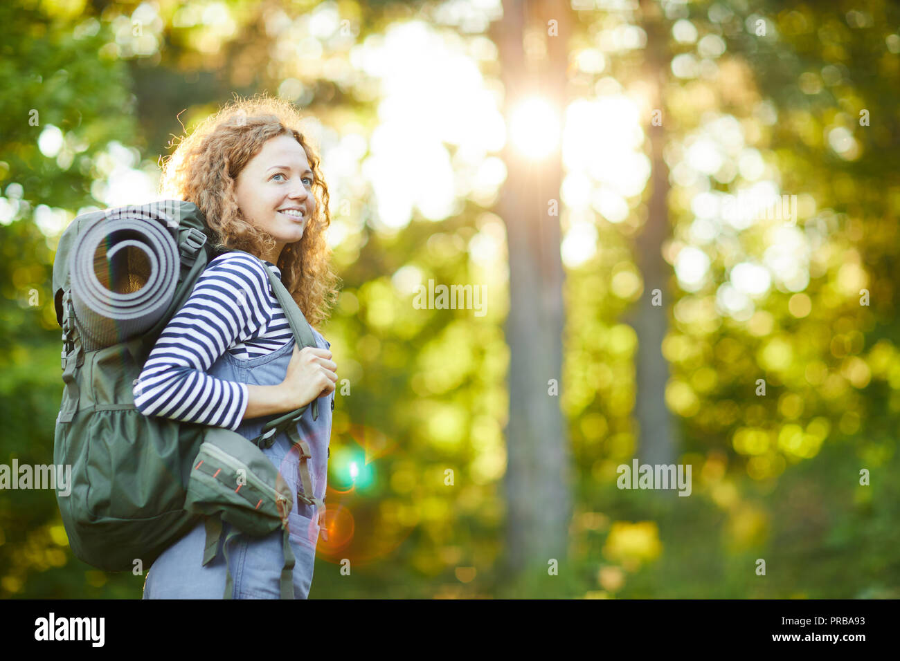 Female camper with backpack looking aroung while searching for camping ...