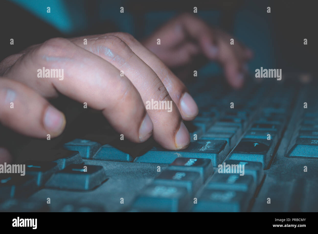 A professional person typing or using an office laptop keyboard. View ...