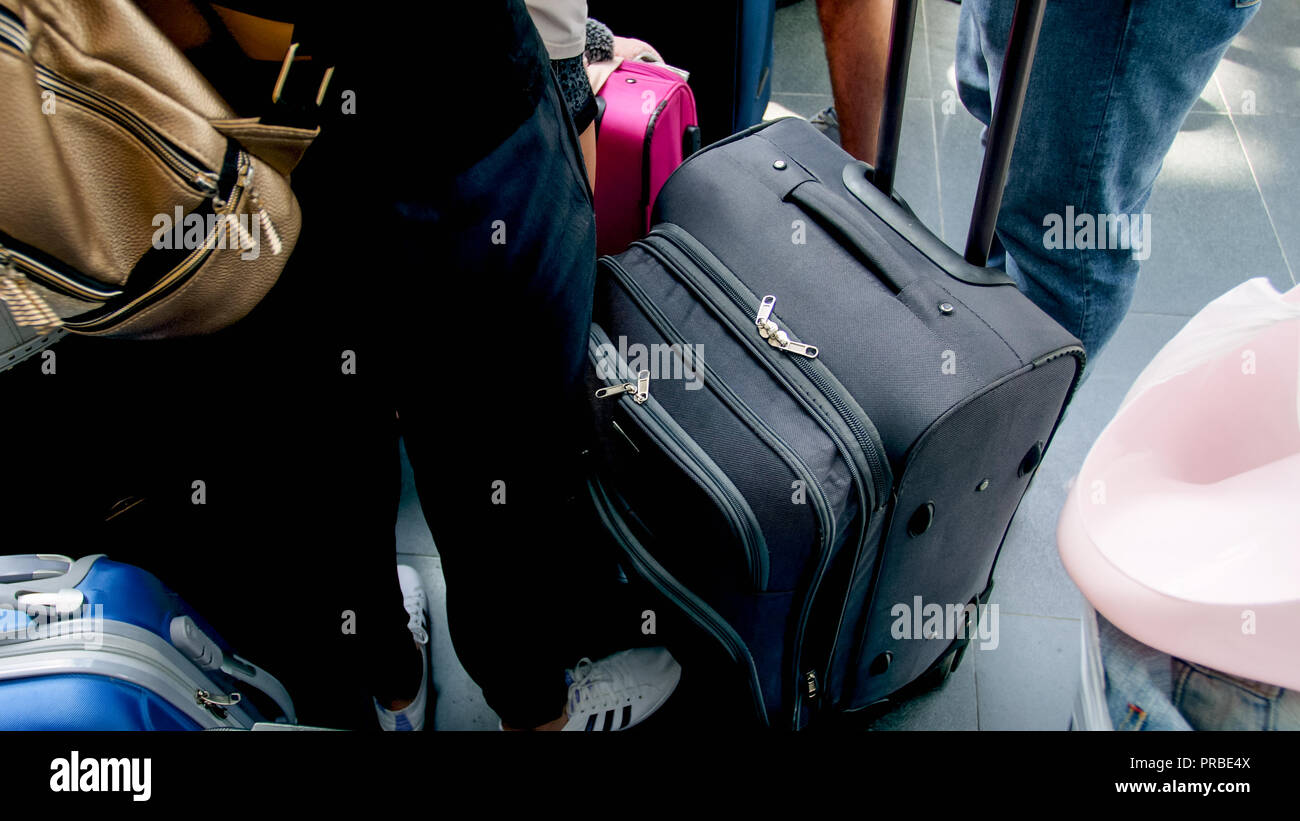 Closeup photo of suitcases and bags on floor at check-in in airport ...