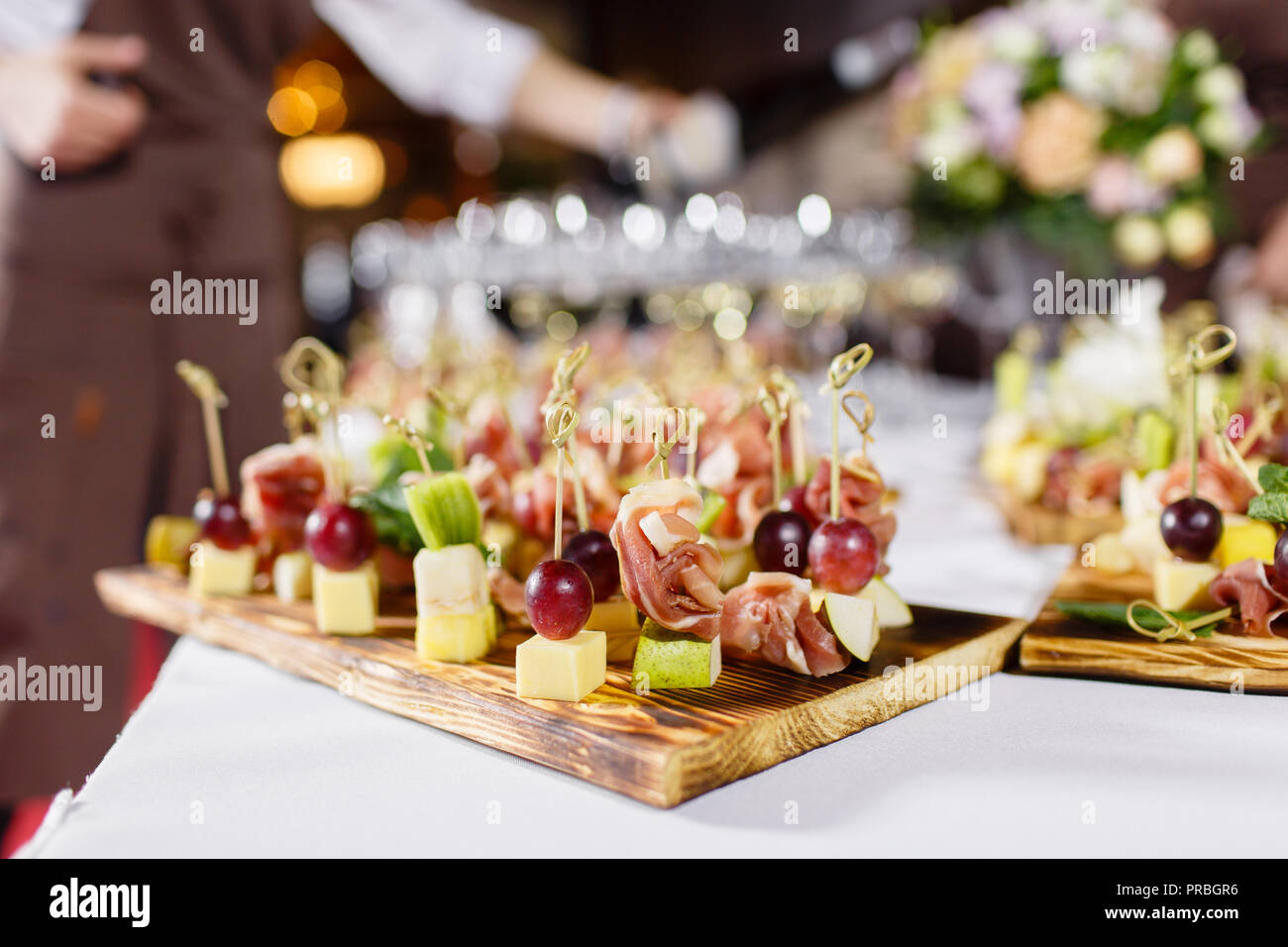 The waiter prepared and serves a snack. the buffet at the reception ...