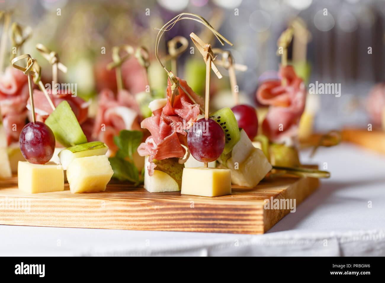 Light snacks in a plate on a buffet table. Assorted mini canapes ...
