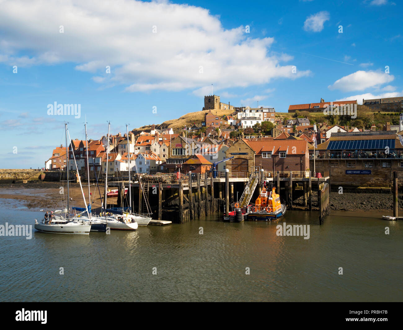 Whitby harbour with the RNLI lifeboat station and St Mary's church in ...