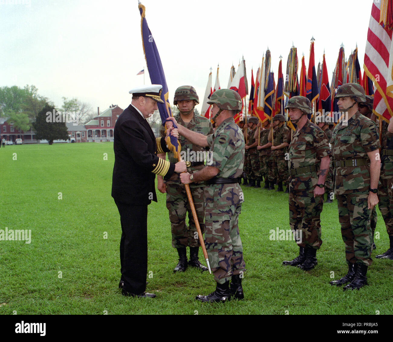 Adm. William Crowe, Jr. passes the ceremonial flag to Gen. Joseph T ...