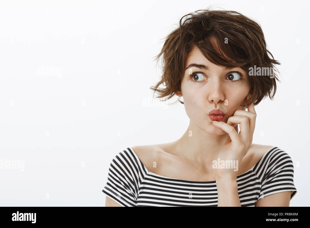 Indoor shot of curious emotive young female student with cute messy ...