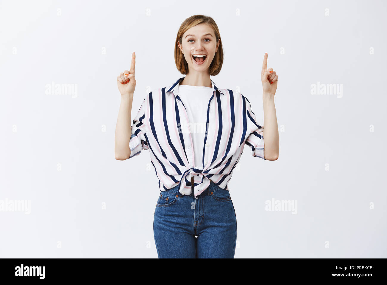 Yeah, I am number one. Portrait of carefree happy woman with short fair ...