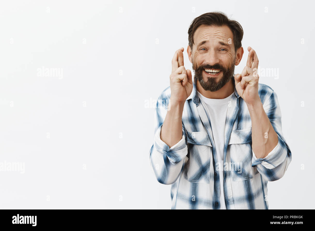 Fingers crossed for good luck. Portrait of nervous charming adult ...