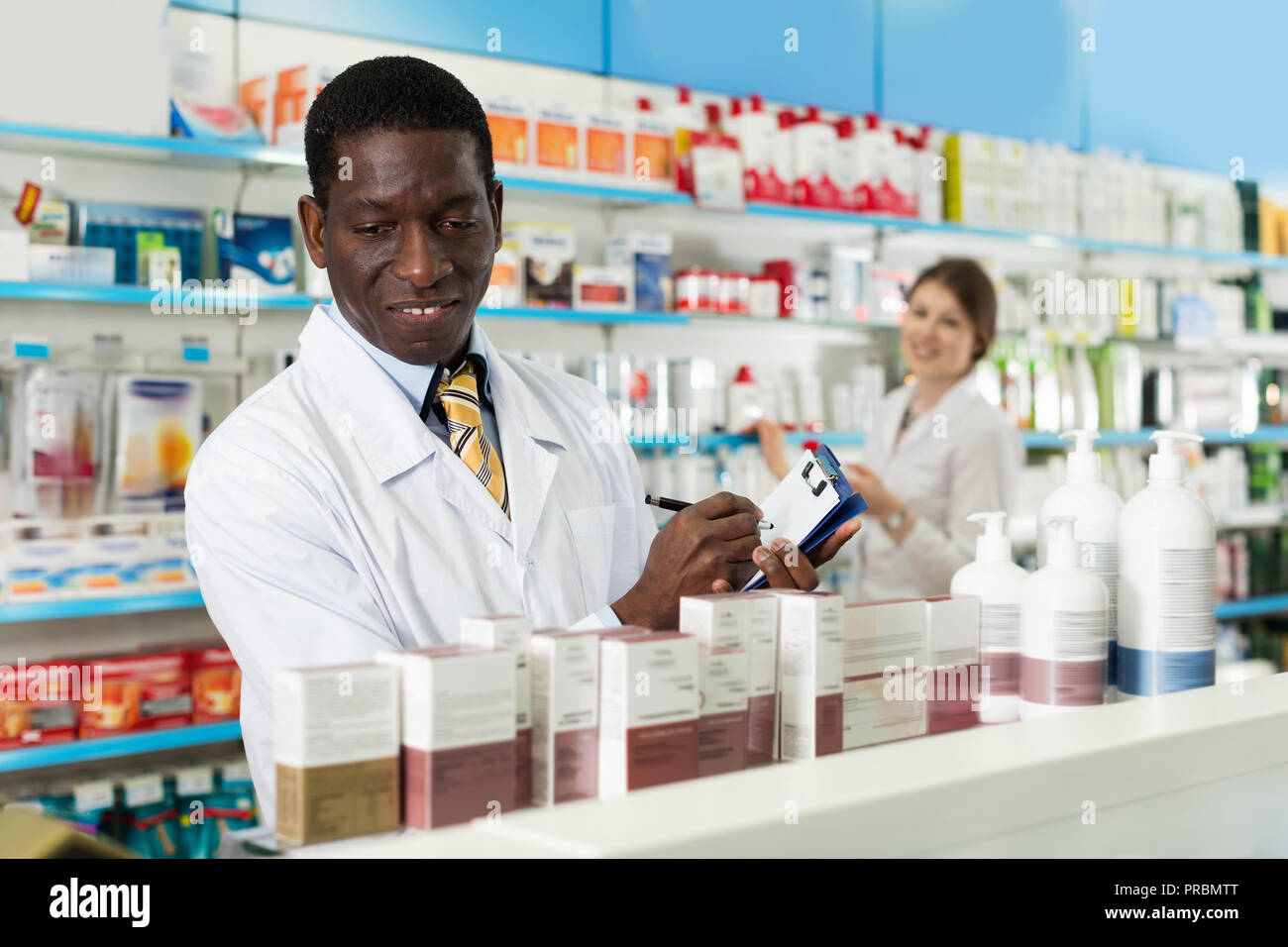 Professional serious positive male pharmacist working at drugstore ...