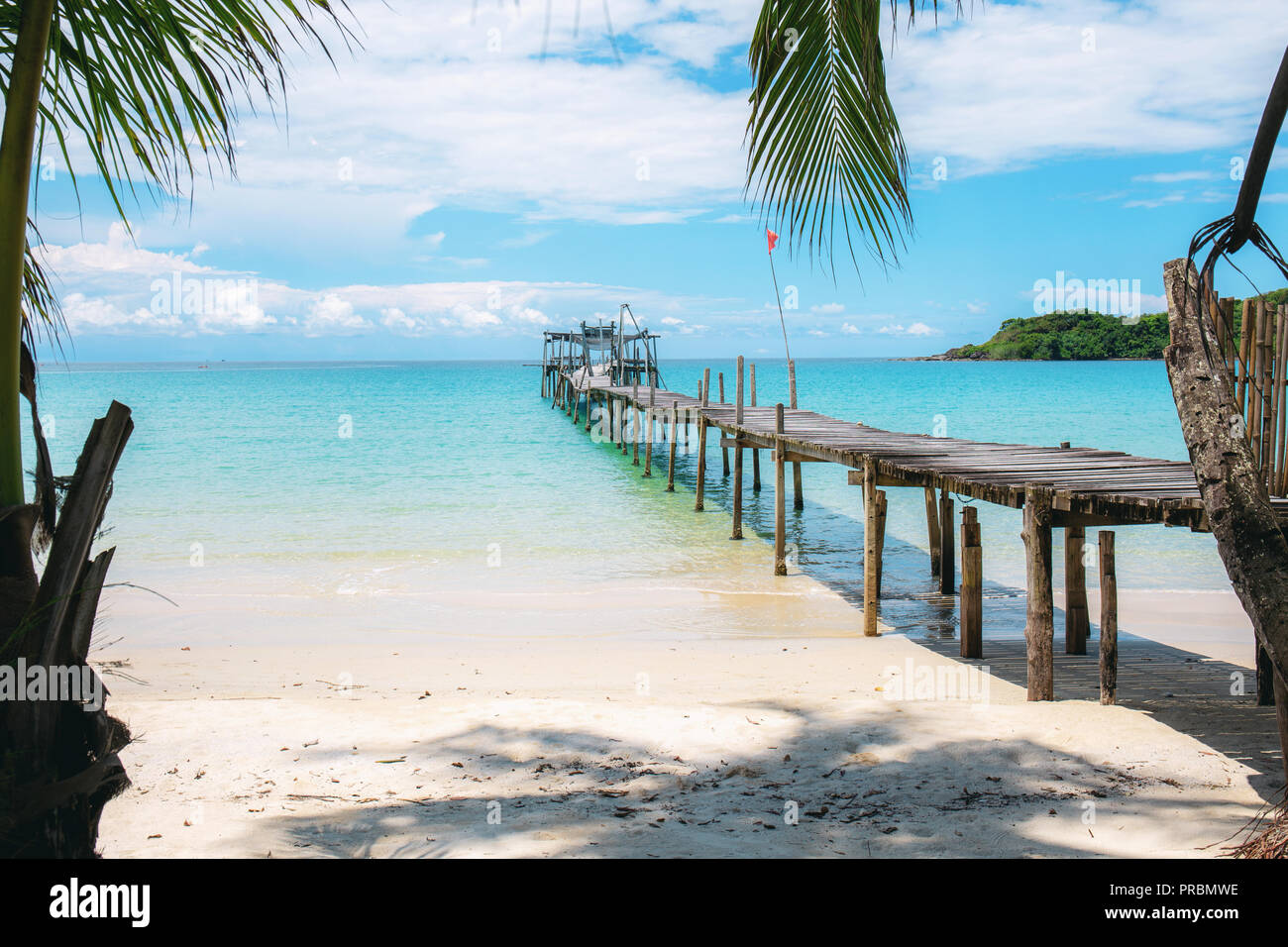 Wooden bridge on beach at the sea with blue sky Stock Photo - Alamy