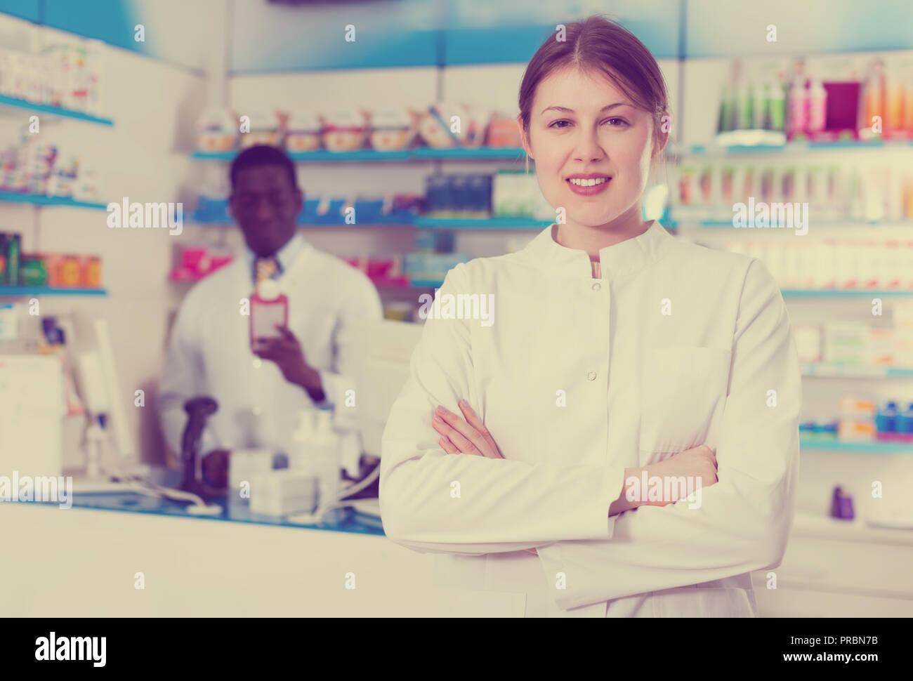 Experienced cheerful positive smiling female pharmacist standing on ...