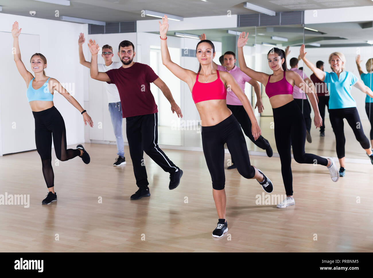 Group of active people training dance together in studio Stock Photo ...