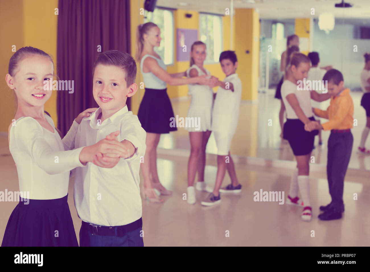 Group of friendly positive children dancing tango in dance studio Stock ...