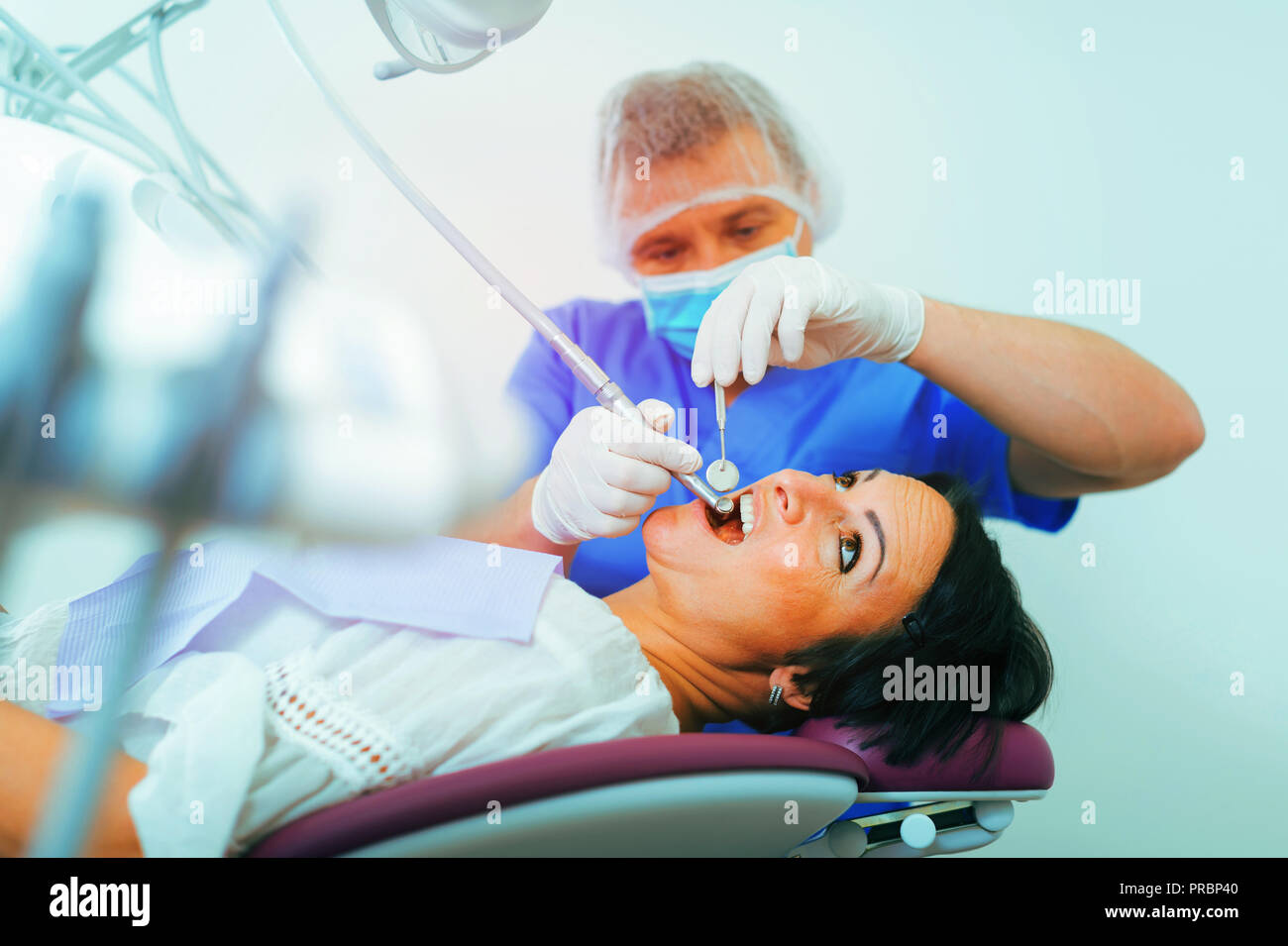 dentist professional filling teeth woman patient sitting in medical chair Stock Photo - Alamy