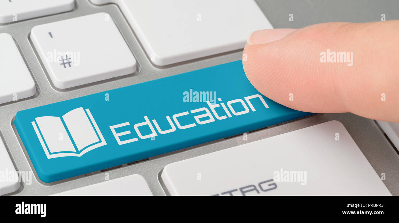 A keyboard with a blue labeled button - Education Stock Photo - Alamy
