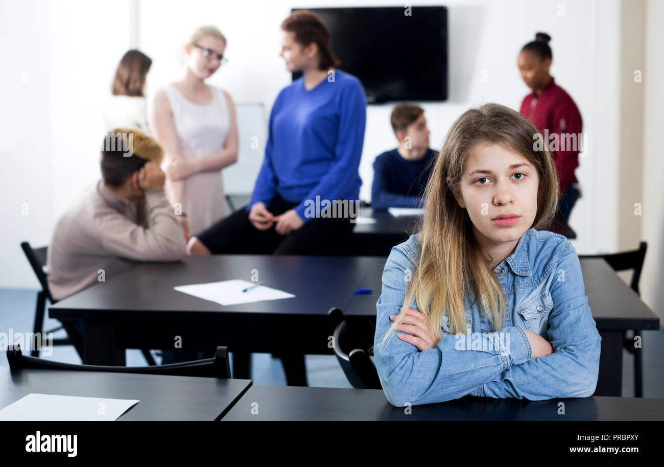 Attractive new girl student being shy among classmates at recess in ...