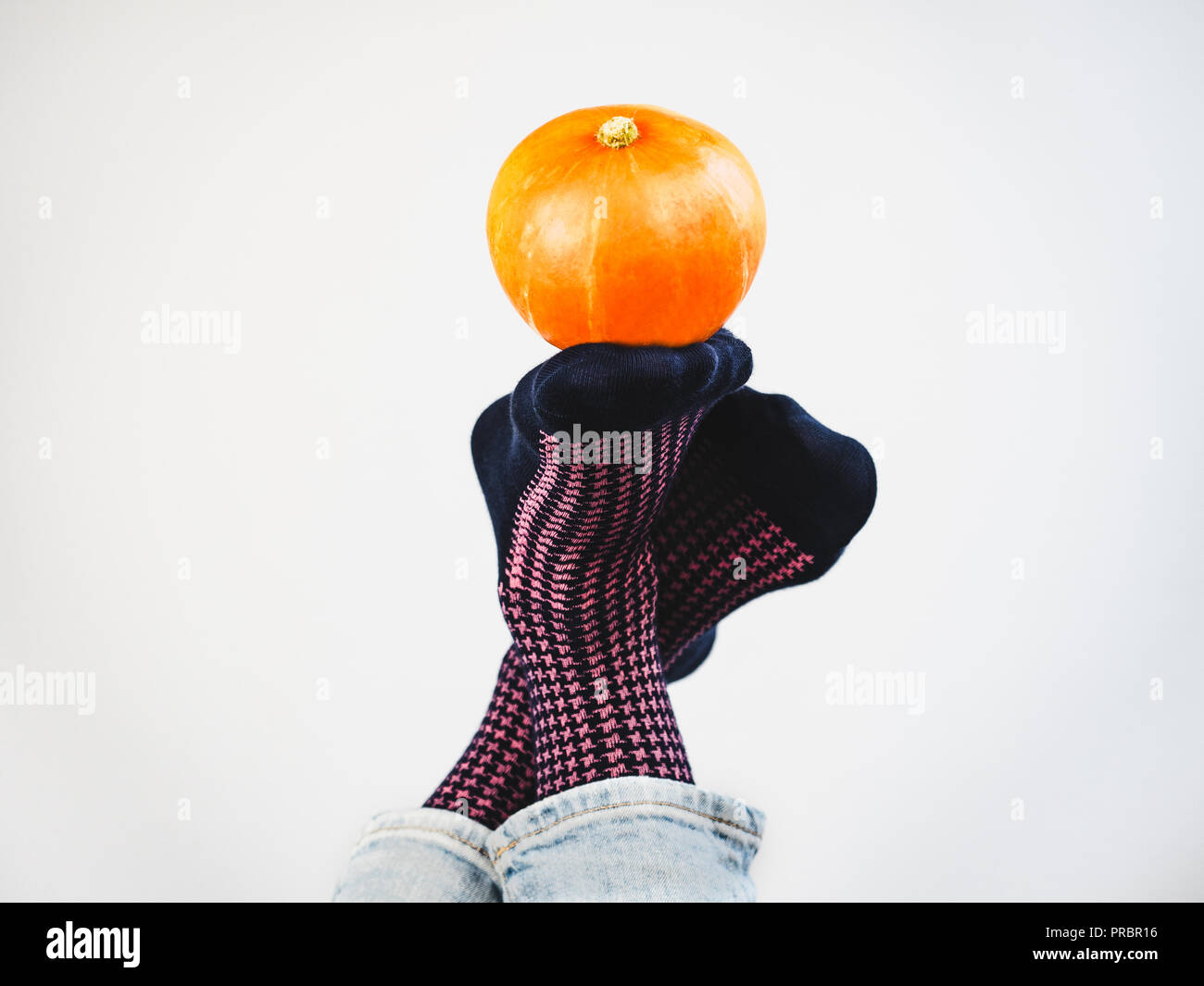 Ripe pumpkin, men's legs and funny socks Stock Photo - Alamy