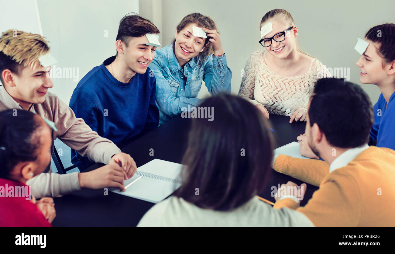 Fellow students playing guess-who game during the school day Stock ...