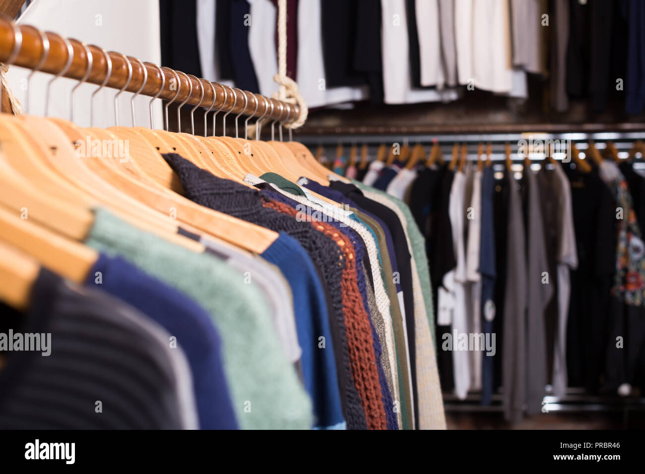 photograph of different colored clothes in the modern shopping centre ...